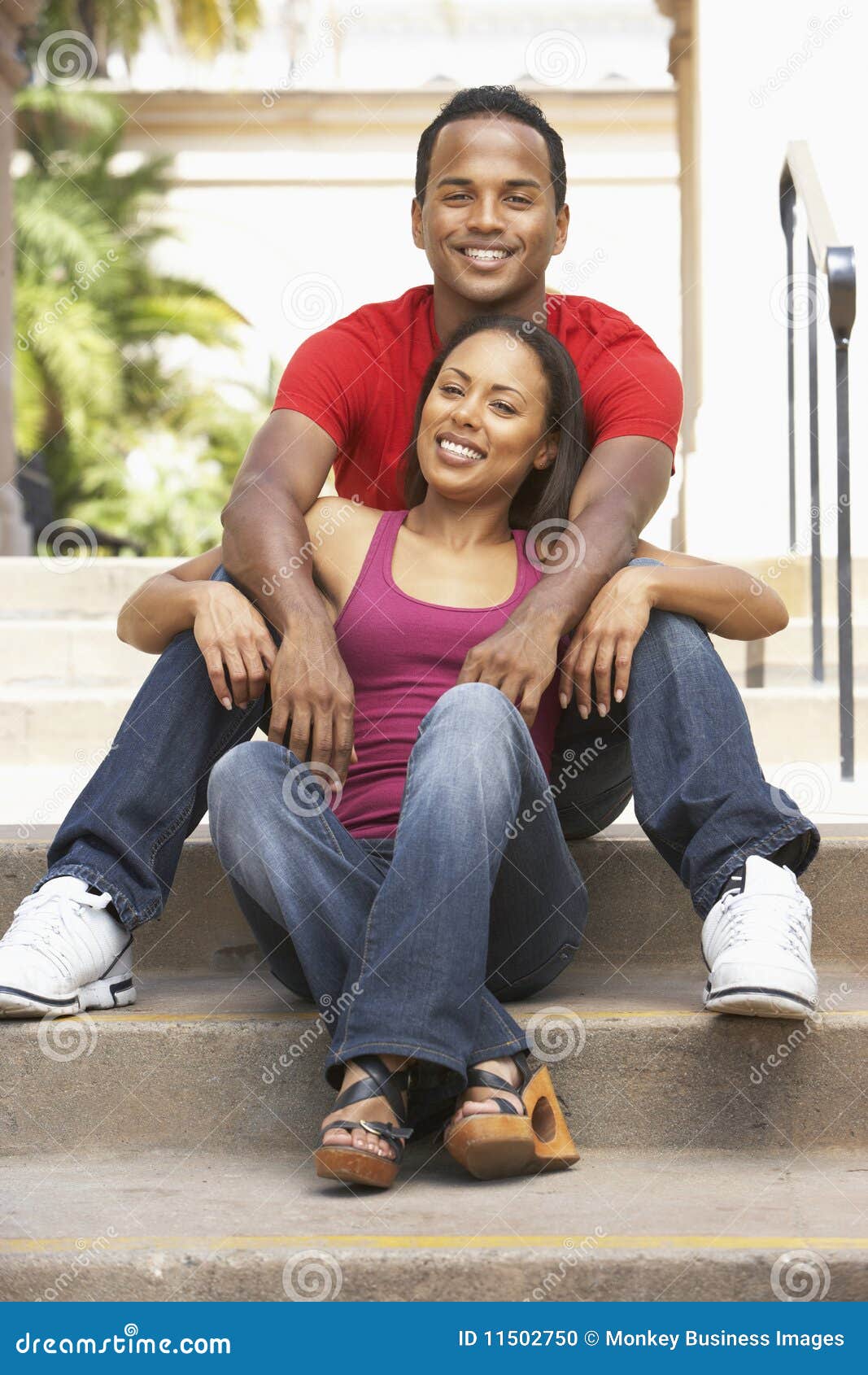 Young Couple Sitting on Steps of Building Stock Photo - Image of ...