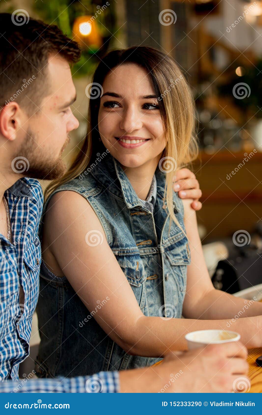 Couple Sitting at a Table in a Cafe and Drinking Coffee Stock Photo ...