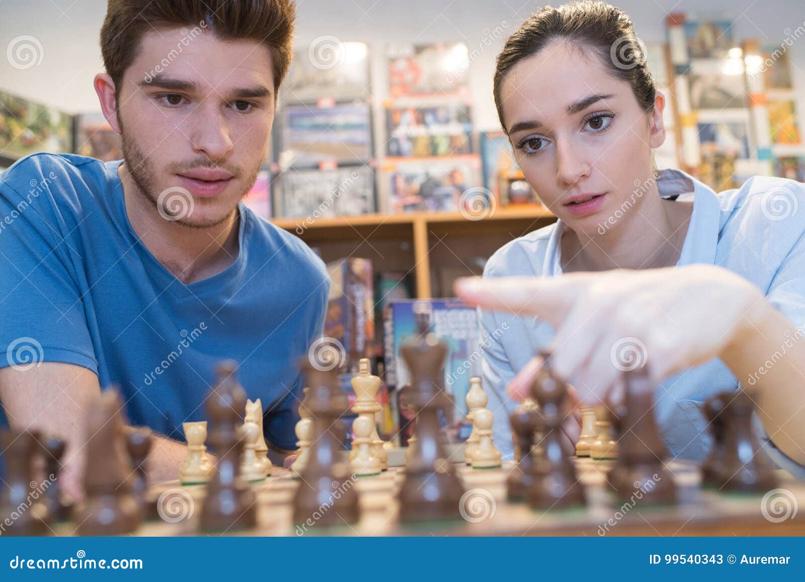Young Couple Sitting at Table and Playing Chess Stock Image - Image of ...