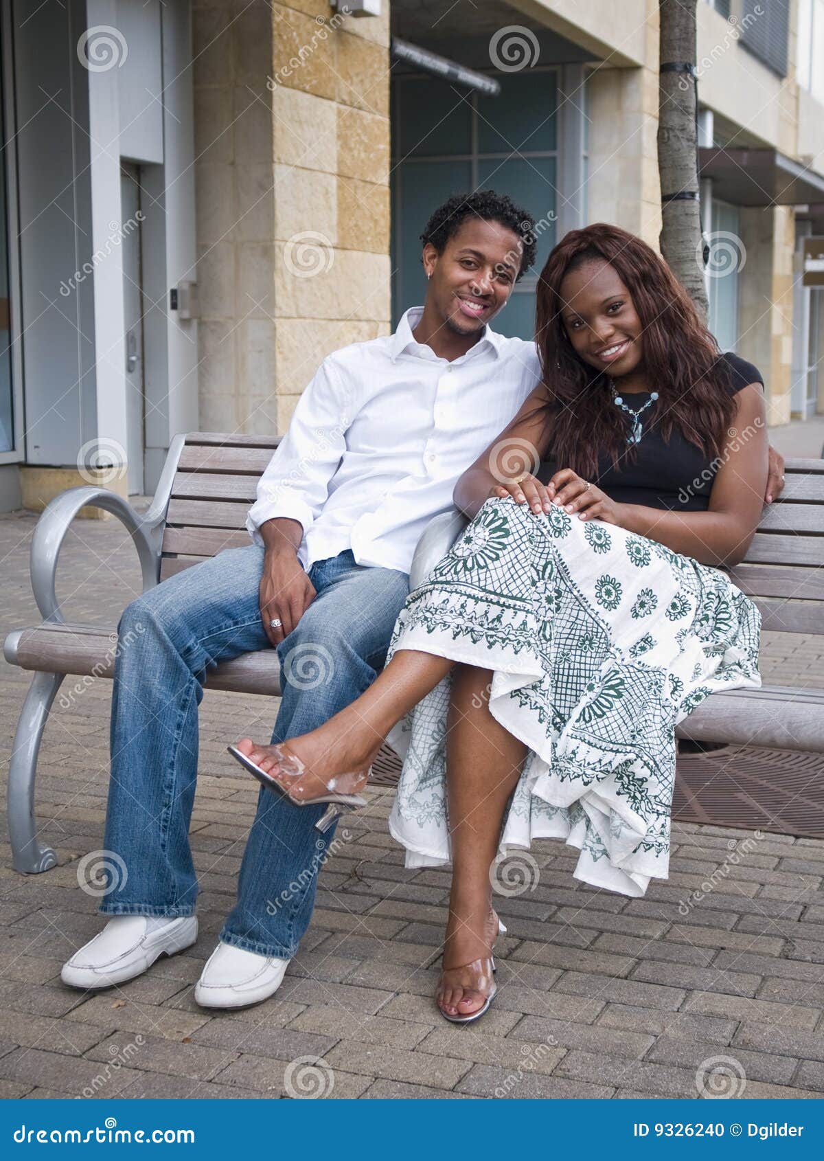 Young Couple Sitting Together Stock Photo - Image of looking, bench ...