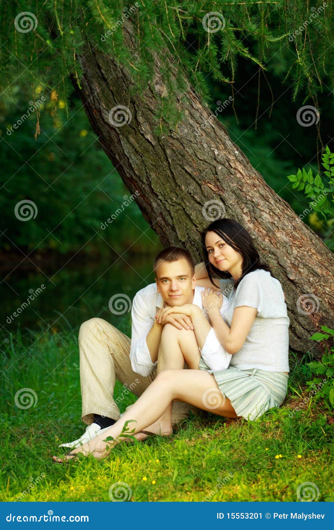 Young Couple Sitting Under Tree Stock Image - Image of loving, sitting ...