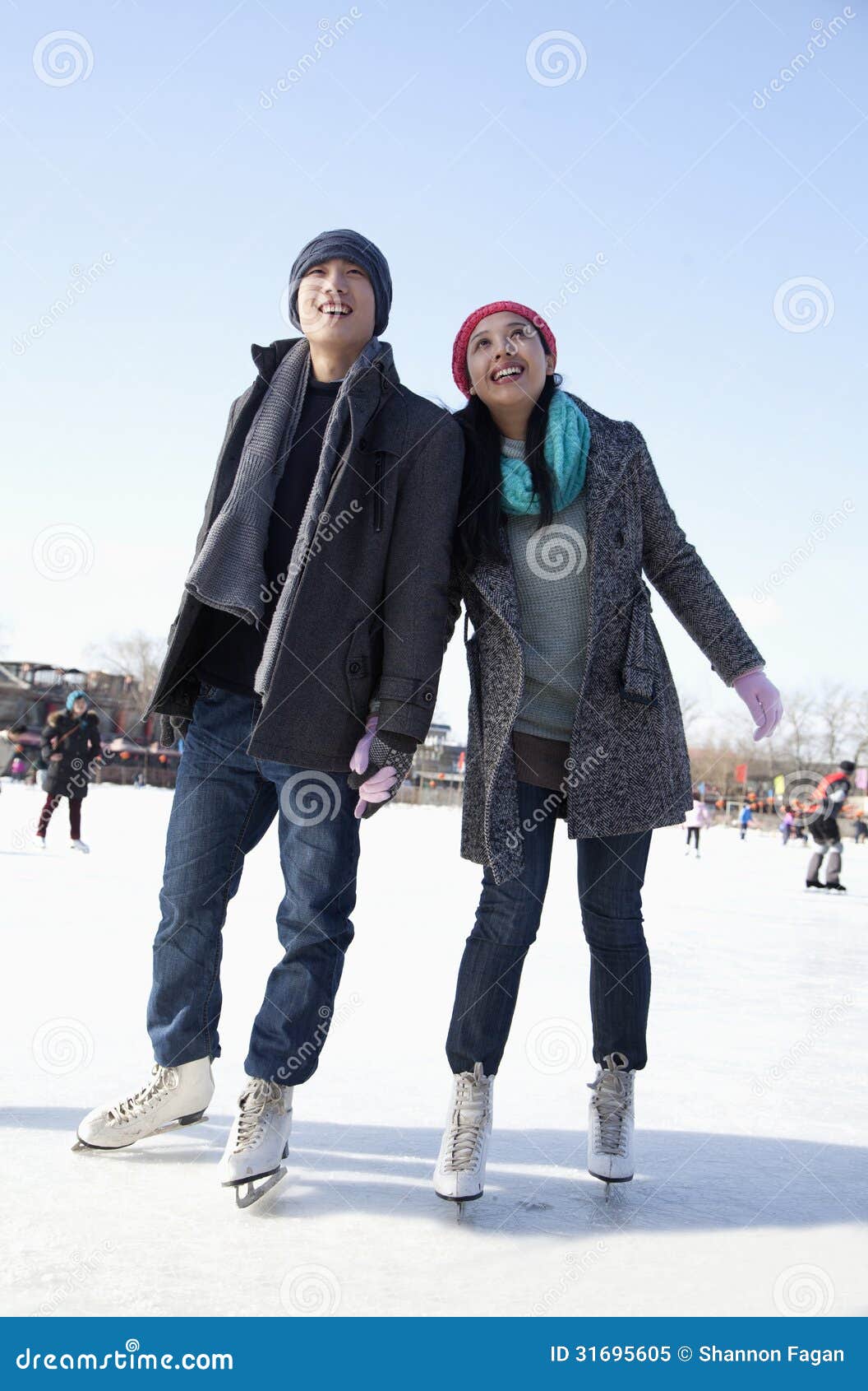 Young Couple Skating at Ice Rink Stock Image - Image of jeans ...