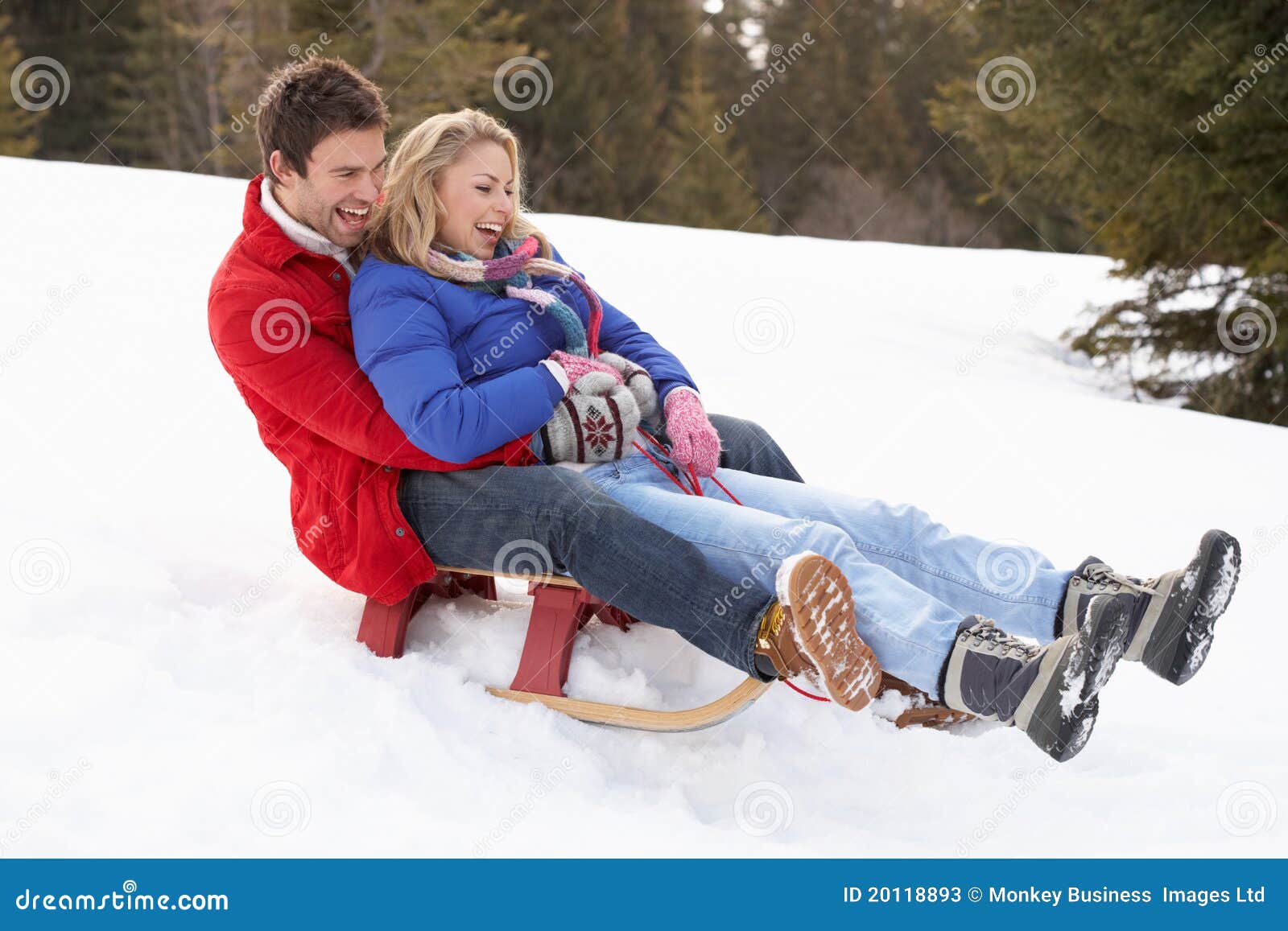 Young Couple Sledding stock image. Image of laughing - 20118893