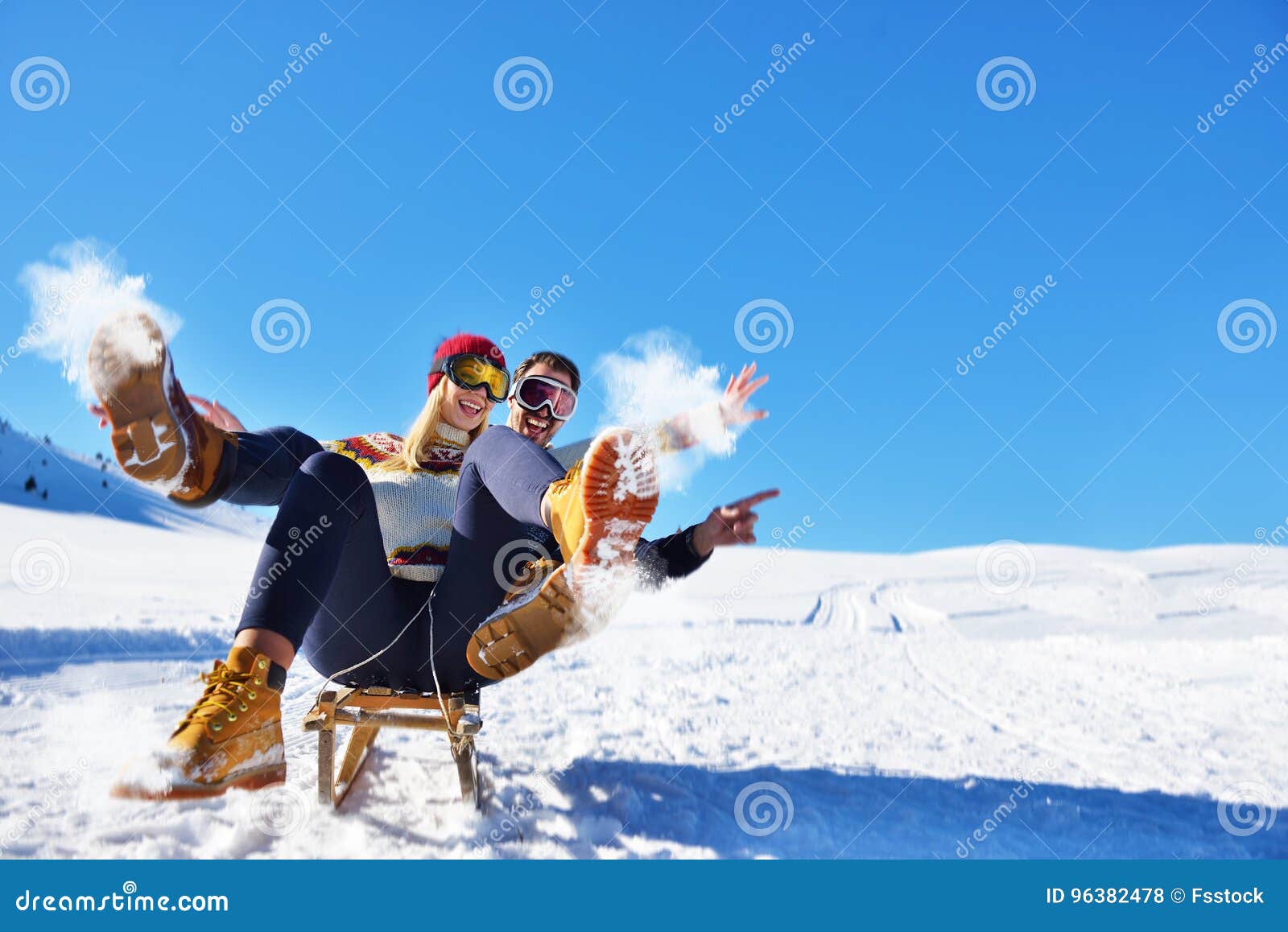 Young Couple Sledding and Enjoying on Sunny Winter Day Stock Photo ...