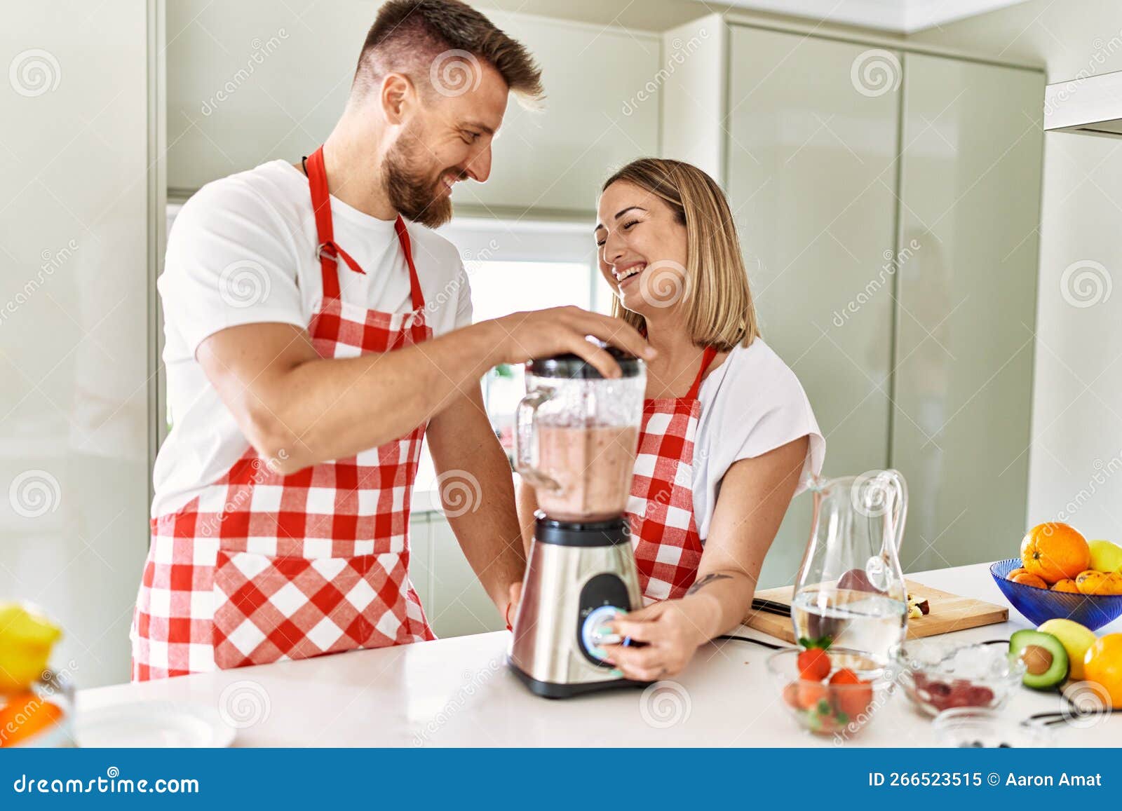 Young Couple Smiling Confident Making Smoothie Using Blender at Kitchen ...