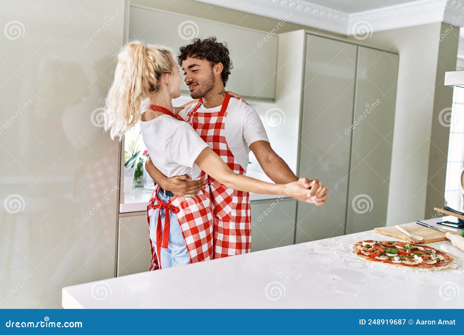 Young Couple Smiling Happy Cooking and Dancing at Kitchen Stock Image ...