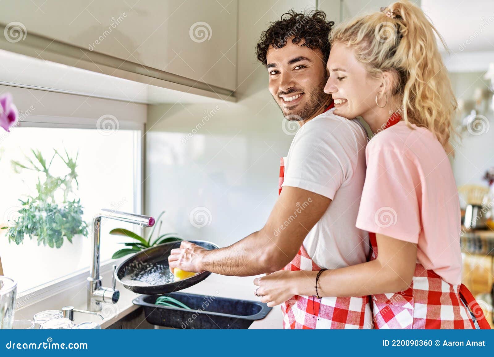 Young Couple Smiling Happy and Hugging Washing Dishes at Kitchen Stock ...