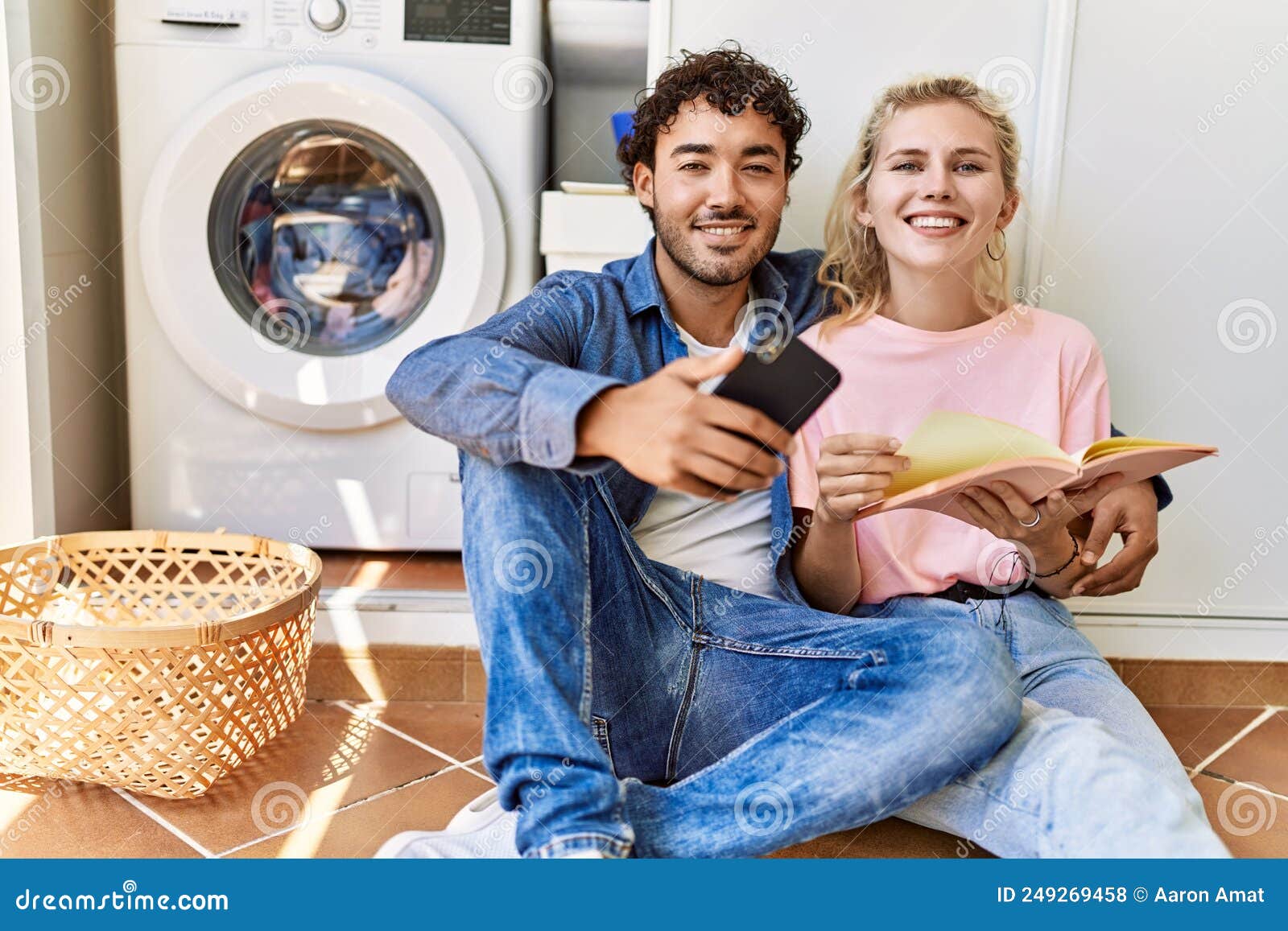 Young Couple Smiling Happy Reading Book and Using Smartphone while ...