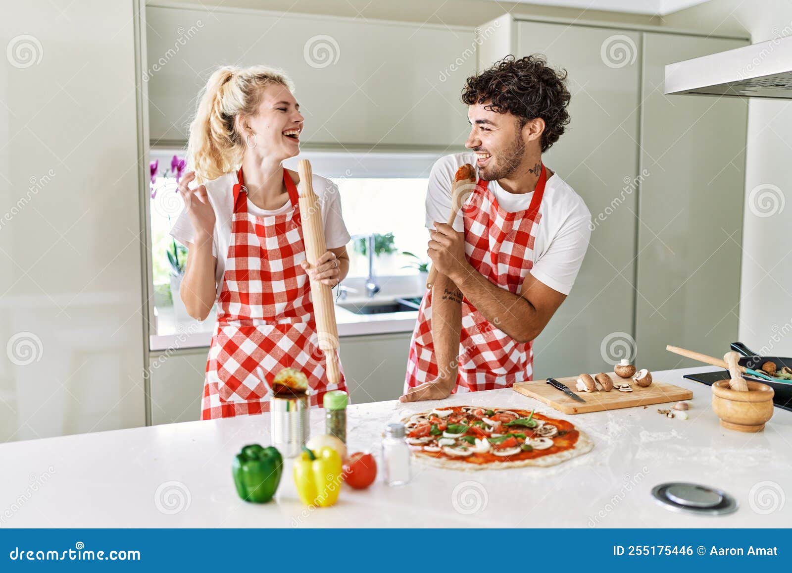 Young Couple Smiling Happy and Singing Using Kneader and Spoon As a ...