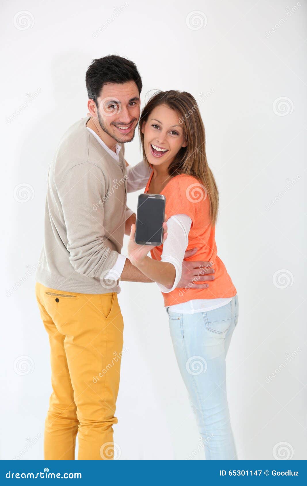 Young Couple Smiling and Showing Smartphone Stock Image - Image of ...