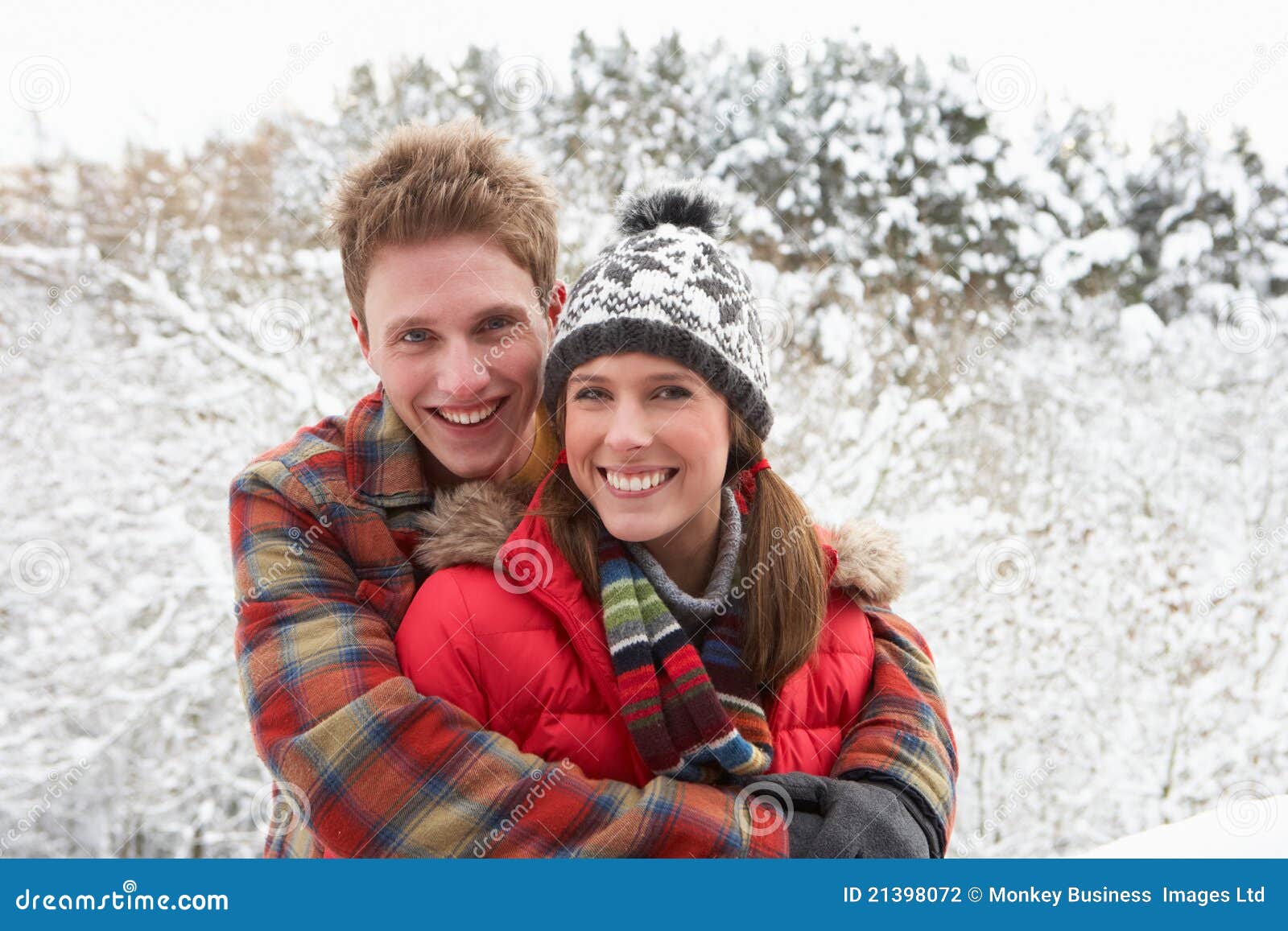 Young couple in snow stock photo. Image of affectionate - 21398072