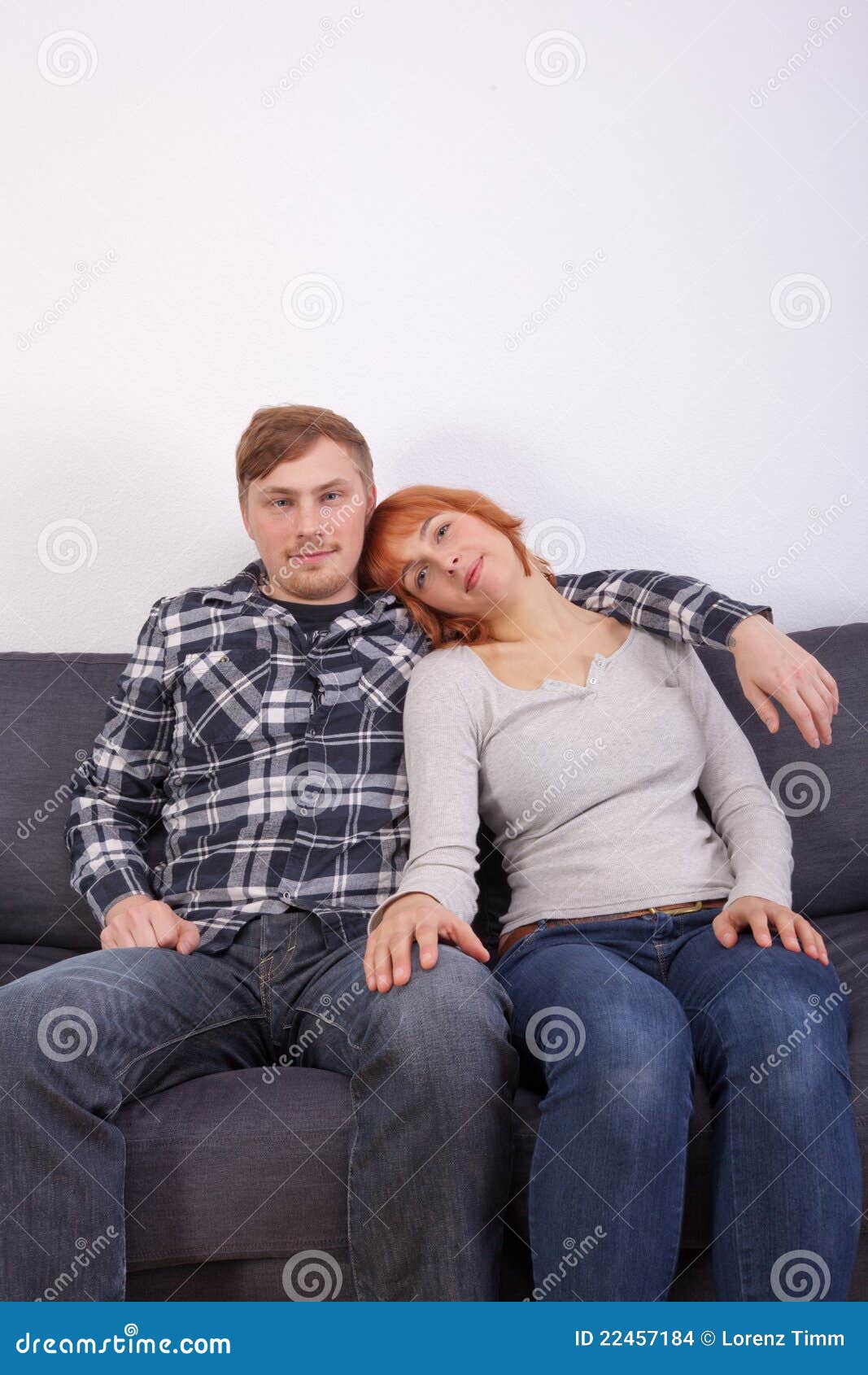 A young couple on a sofa stock photo. Image of couple - 22457184