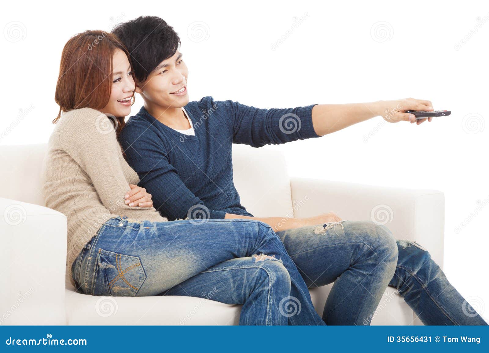 Young Couple on Sofa Watching TV with Remote Control Stock Image ...