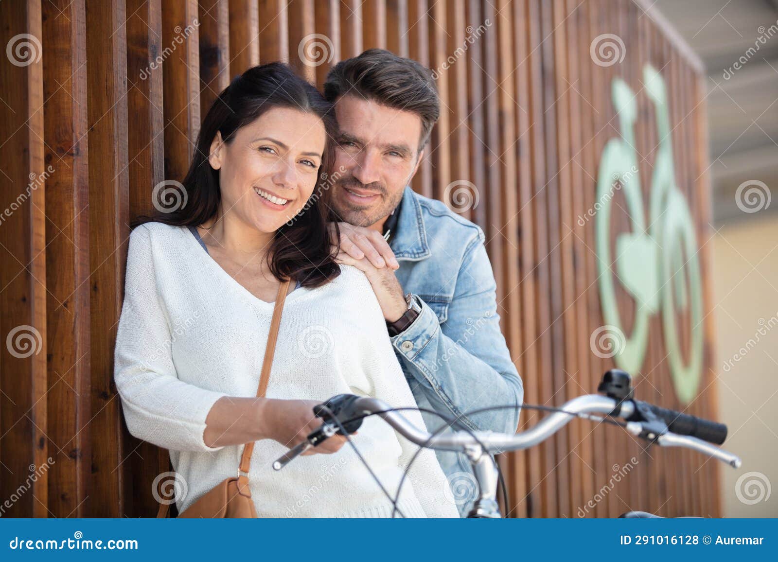 Young Couple Standing Against Wall and Hugging Stock Photo - Image of ...