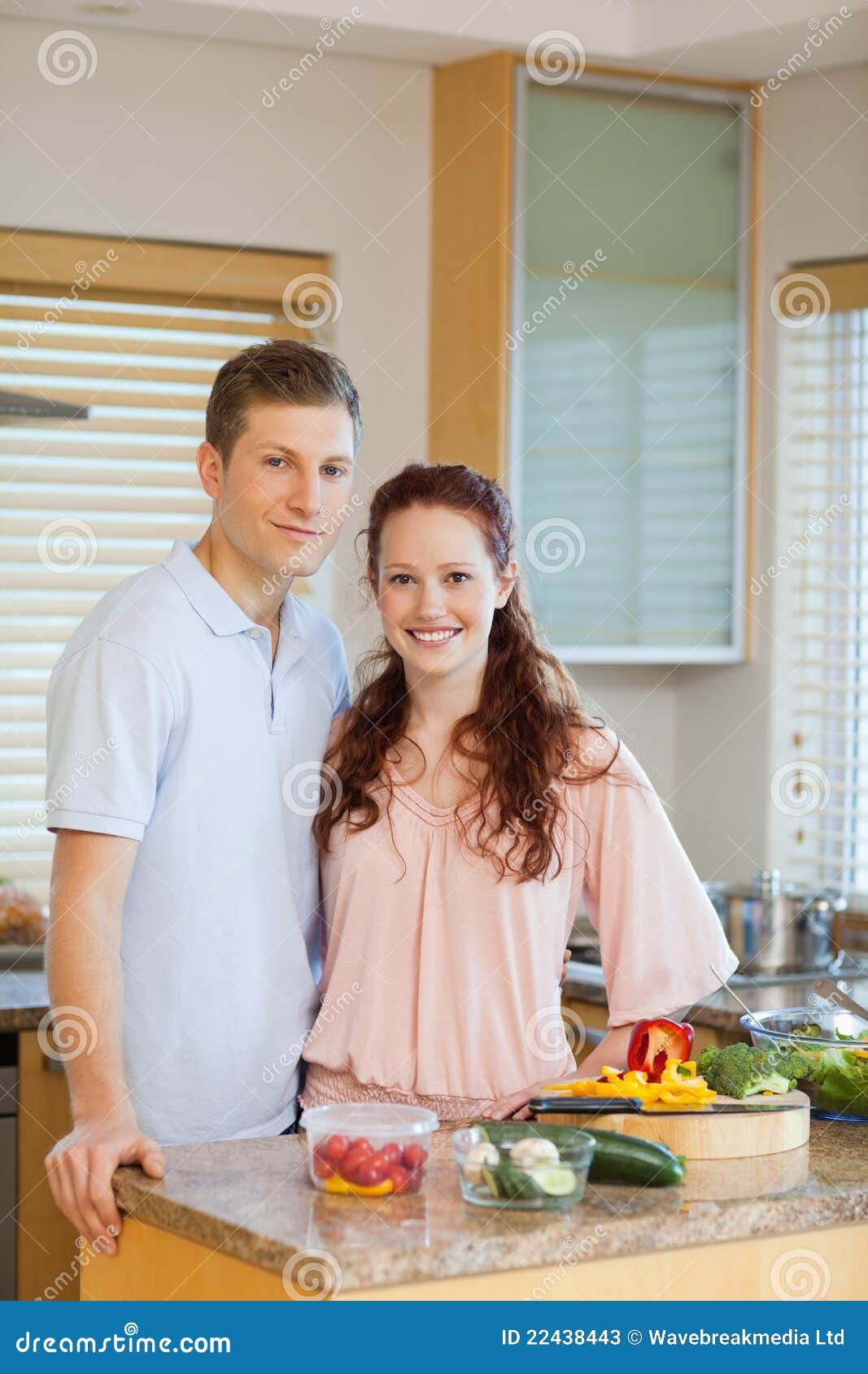 Young Couple Standing Behind Kitchen Counter Stock Image - Image of ...