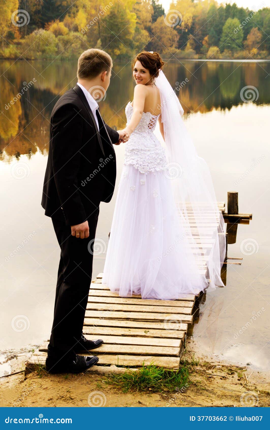 Young Couple Standing on the Bridge Stock Photo - Image of gorgeous ...