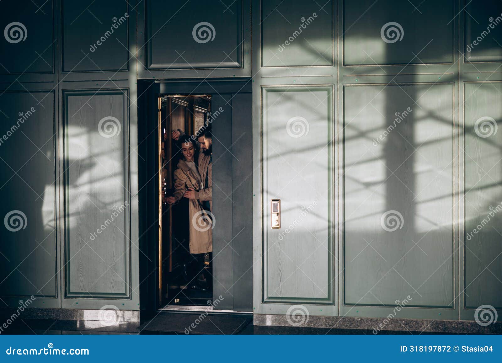 Young Couple Standing Inside Elevator Cabin and Embracing Stock Photo ...