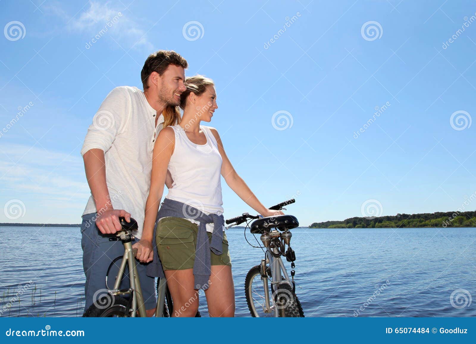 Young Couple Standing by the Lake Stock Photo - Image of panorama, lake ...