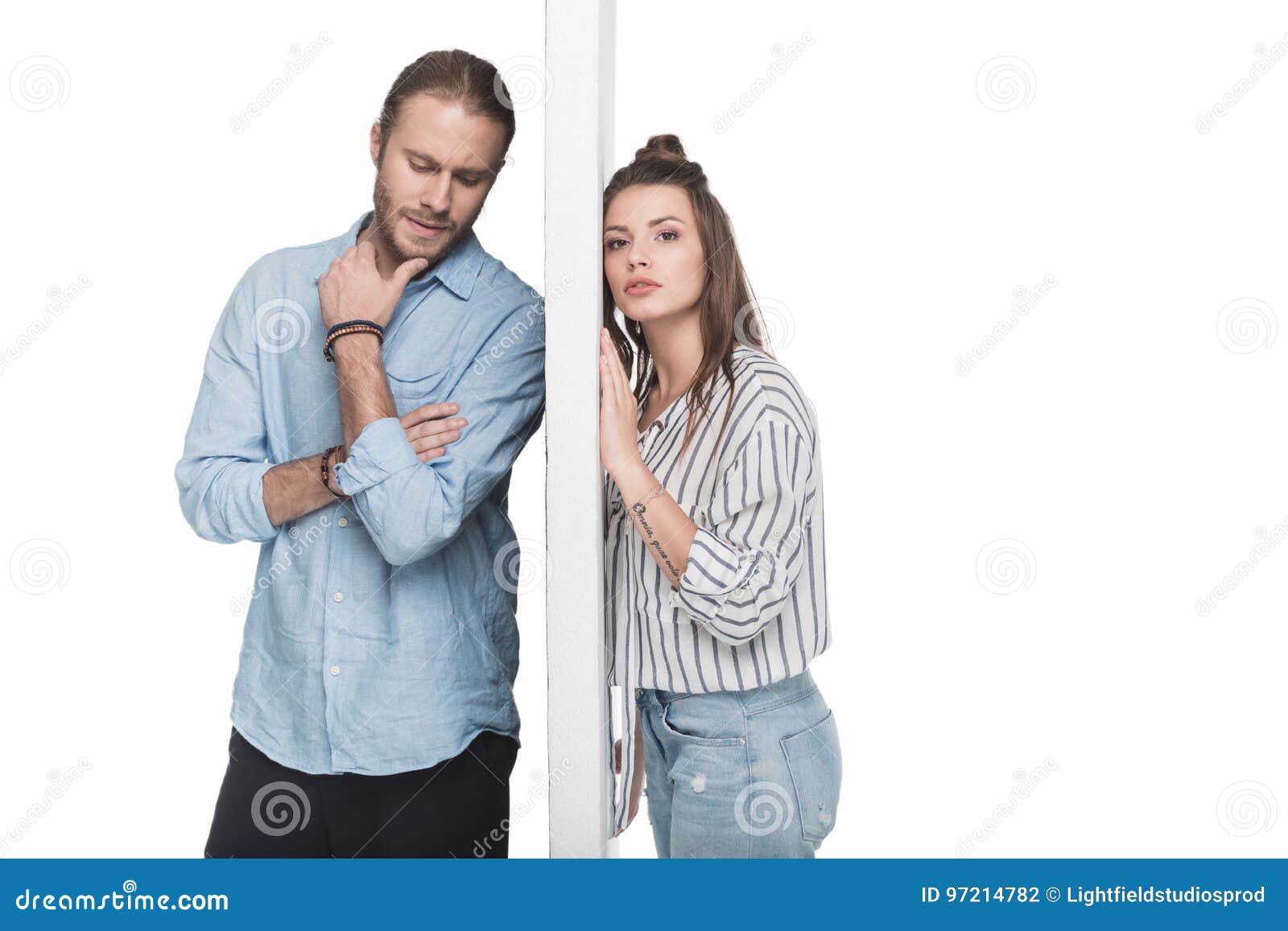 Young Couple Standing Separated by Wall Isolated on White Stock Photo ...
