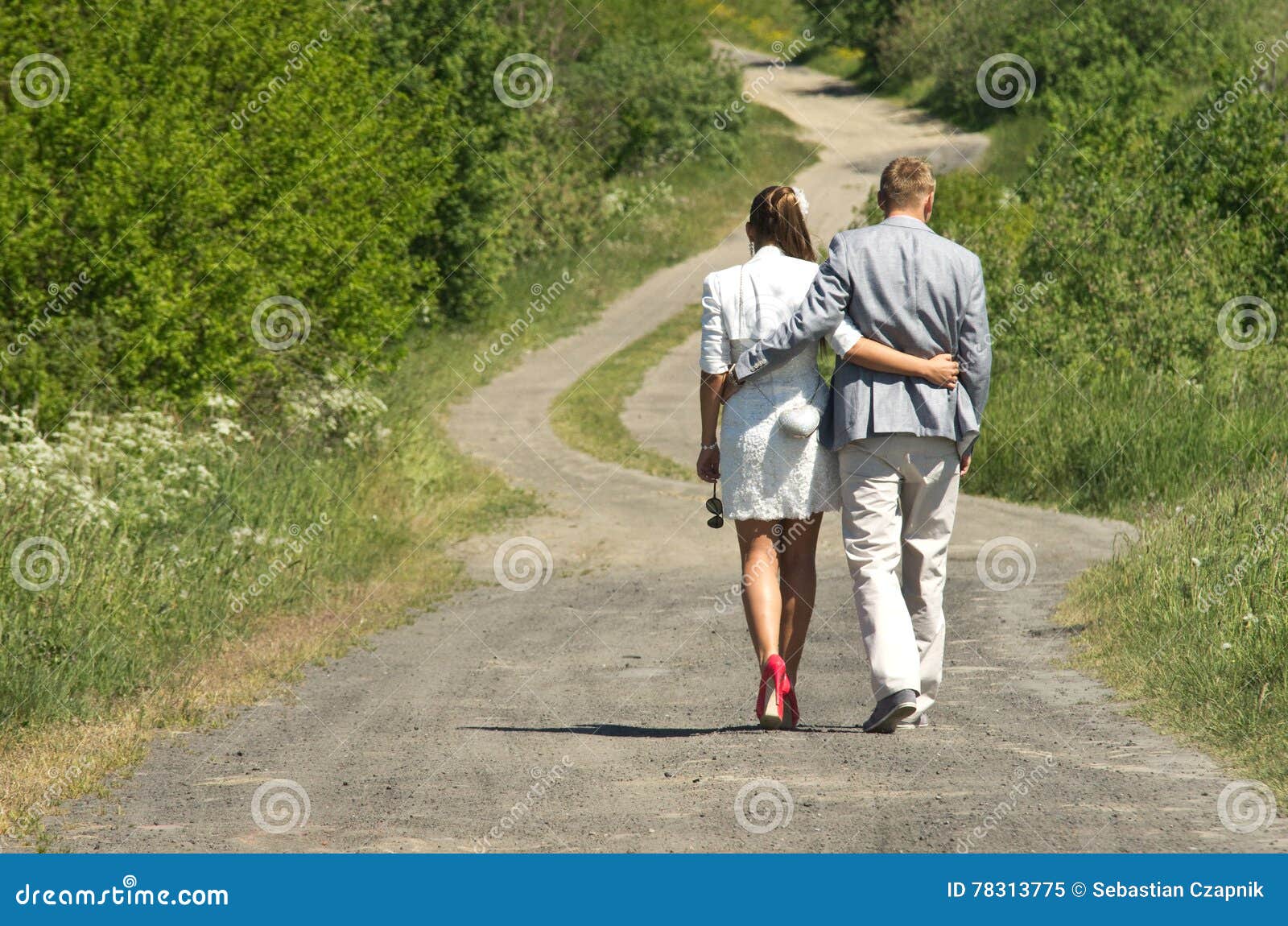 Young Couple Strolling on Road Stock Image - Image of dirt, stroll ...