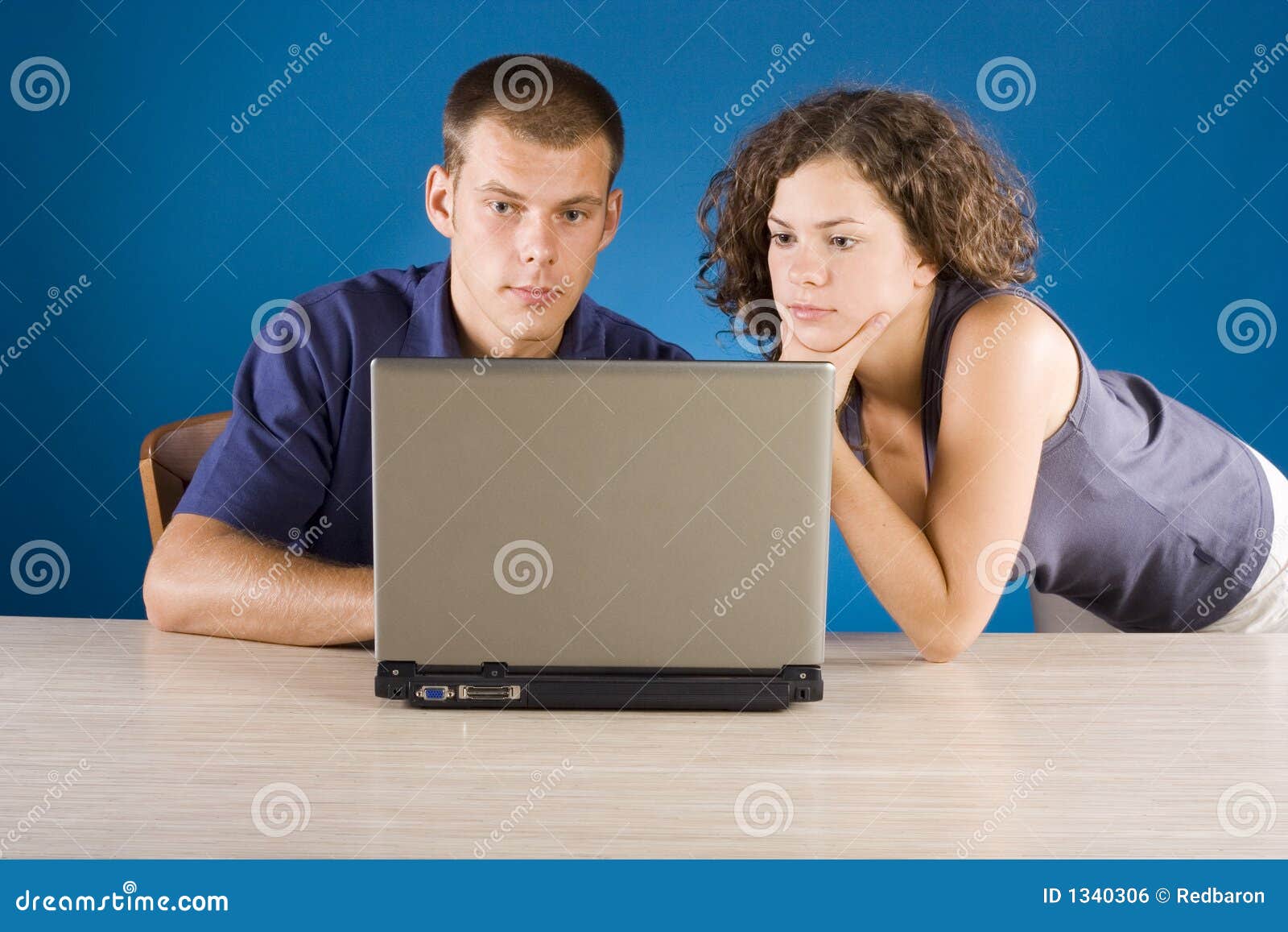 Young Couple at the Table with Laptop Stock Photo - Image of keyboard ...