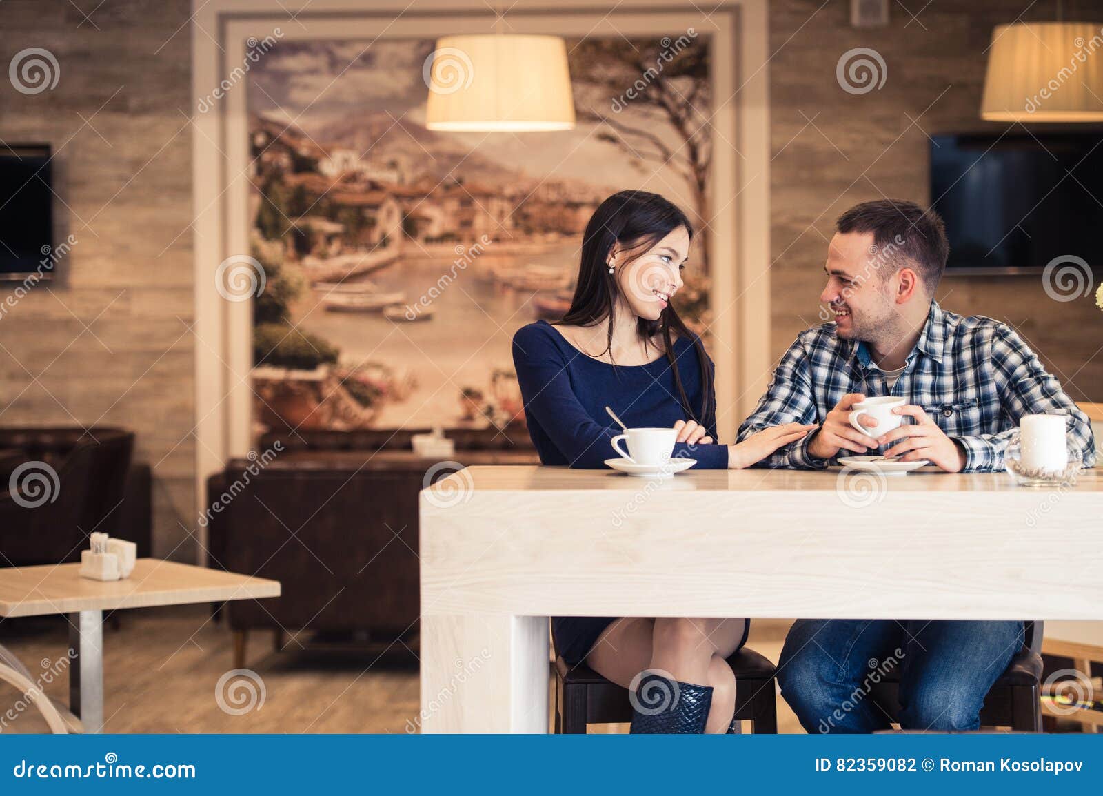 Young Couple Talking in Coffee Shop Stock Photo - Image of adult ...