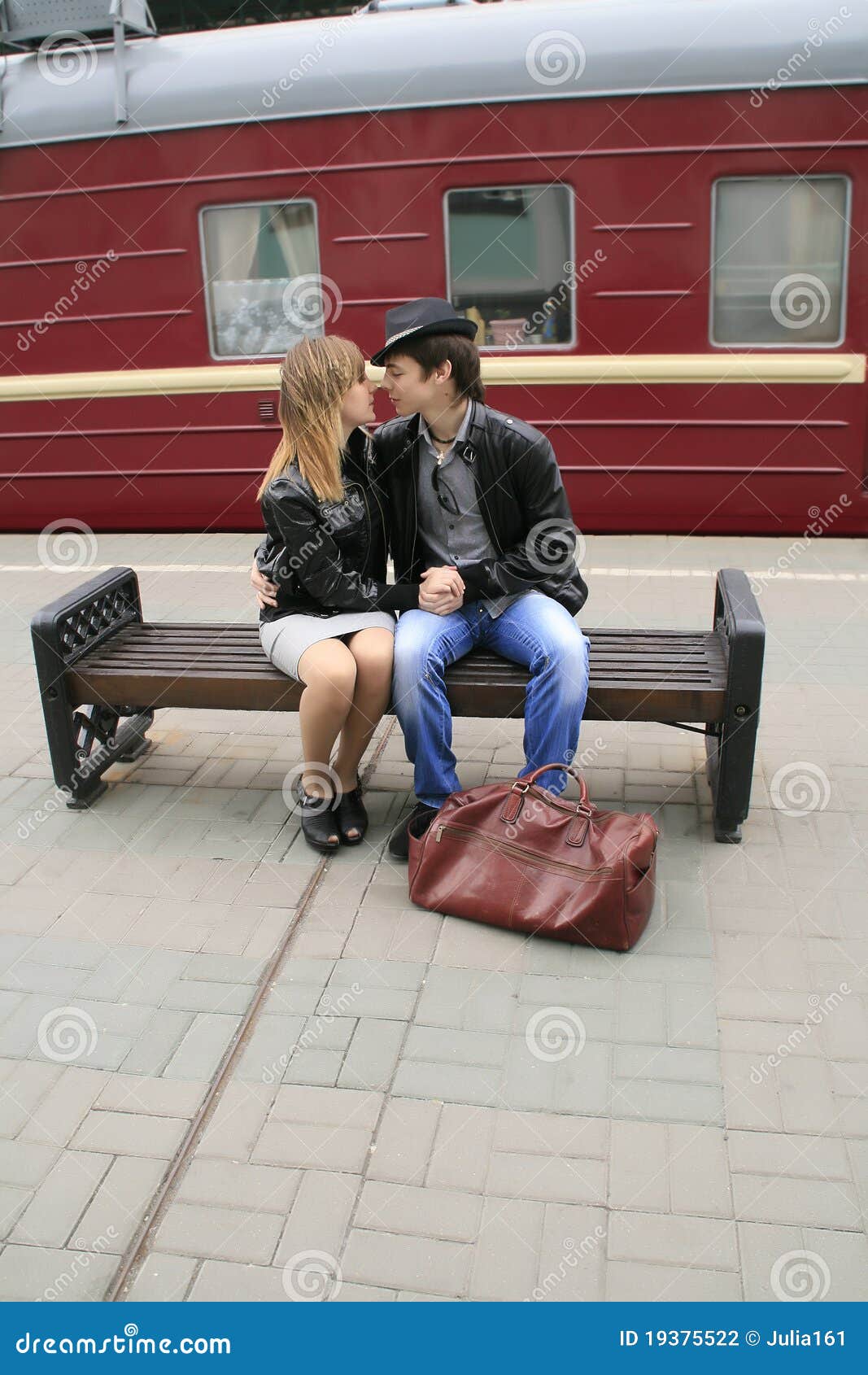 Young couple by train stock photo. Image of seat, bench - 19375522