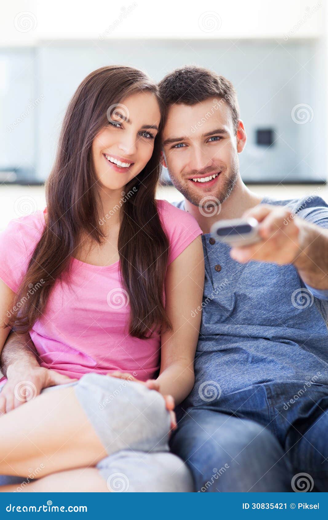 Young Couple with TV Remote Stock Image - Image of smiling, smile: 30835421