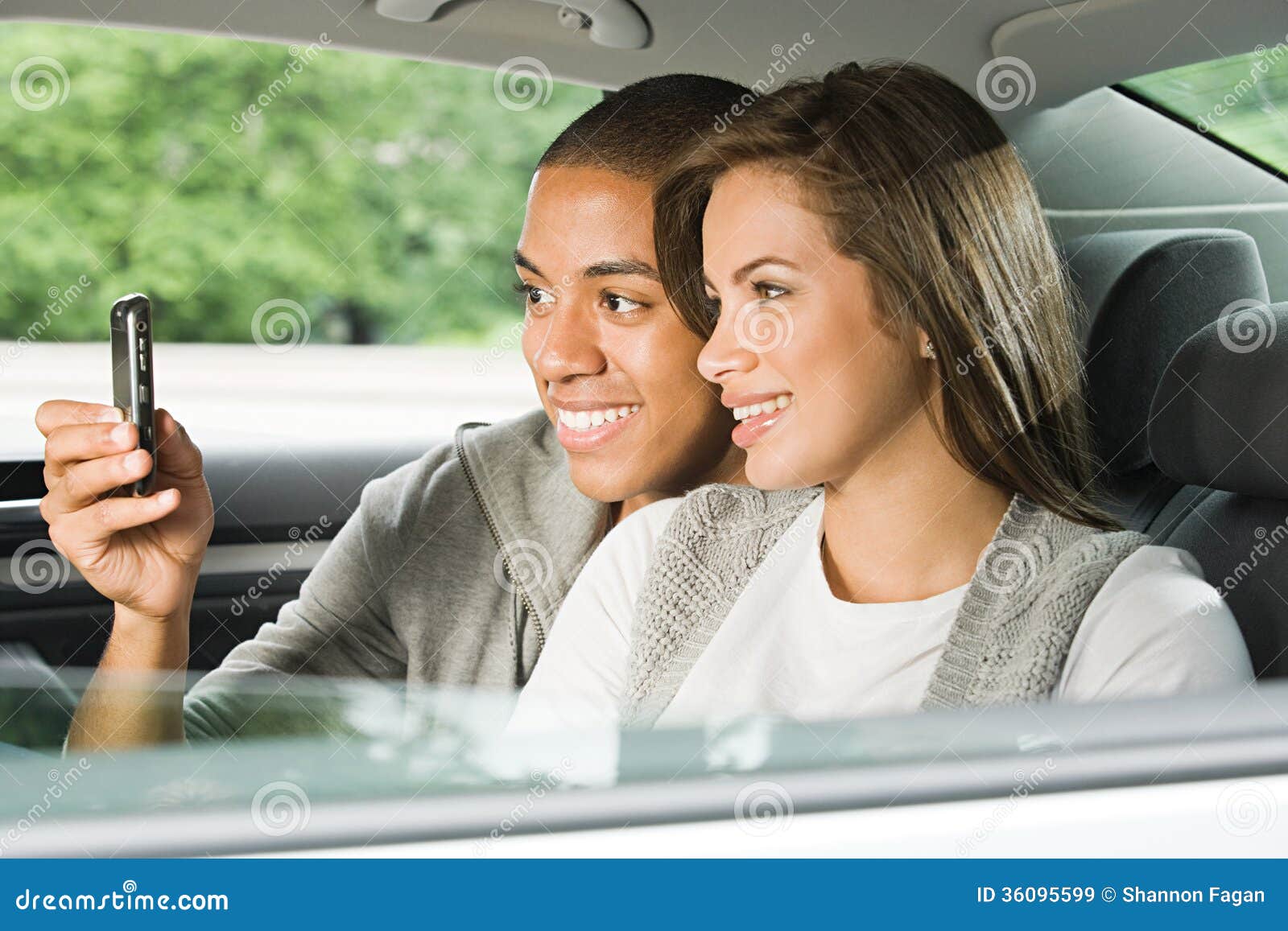 Young Couple Using a Cellular Phone in Car Stock Image - Image of 2025 ...