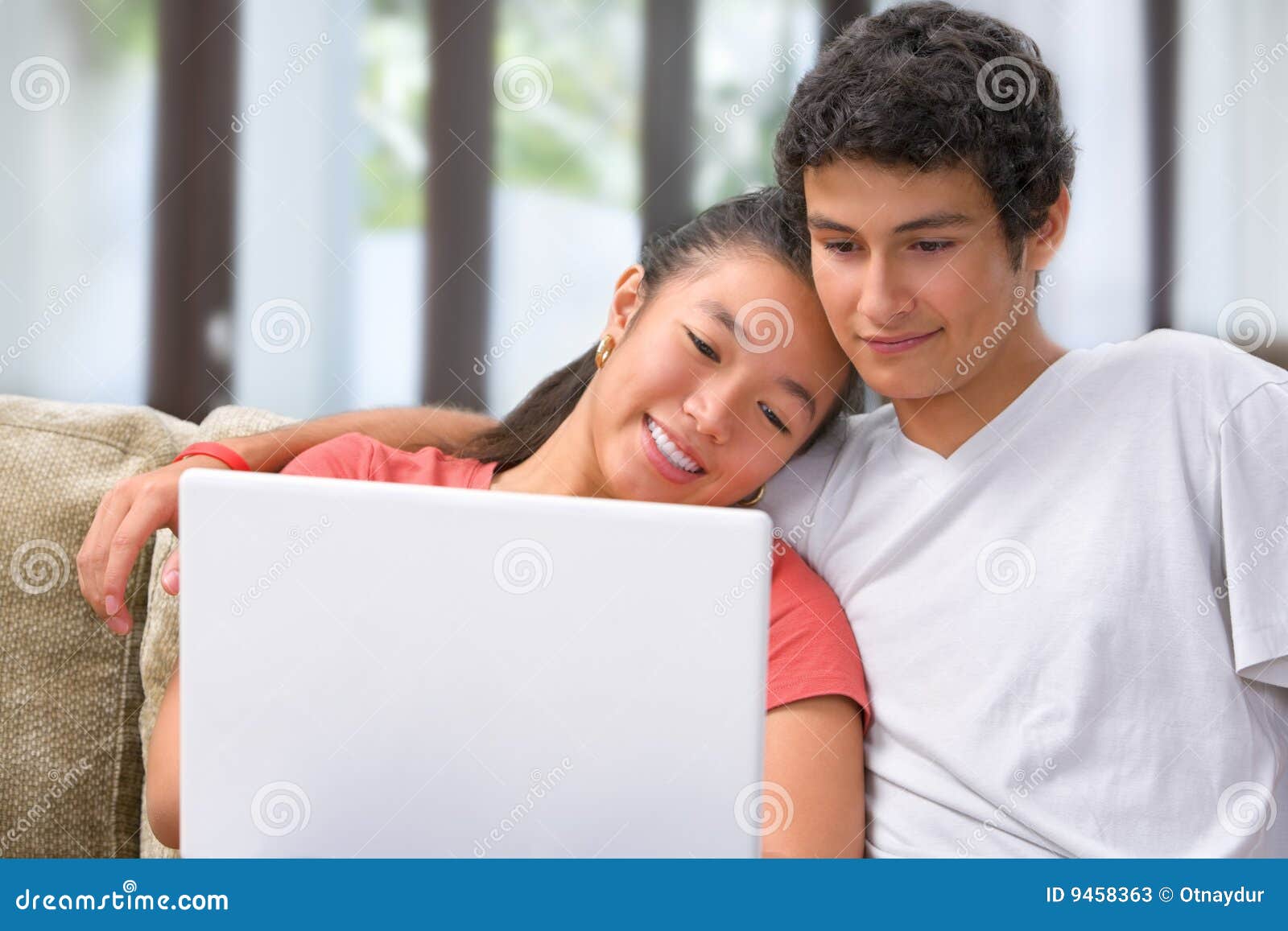 Young couple using laptop stock image. Image of couple - 9458363