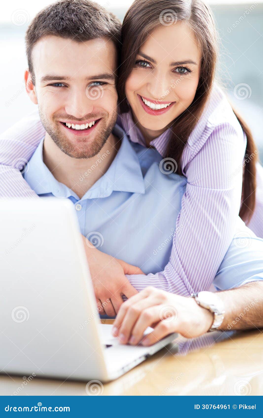 Young couple using laptop stock image. Image of hugging - 30764961