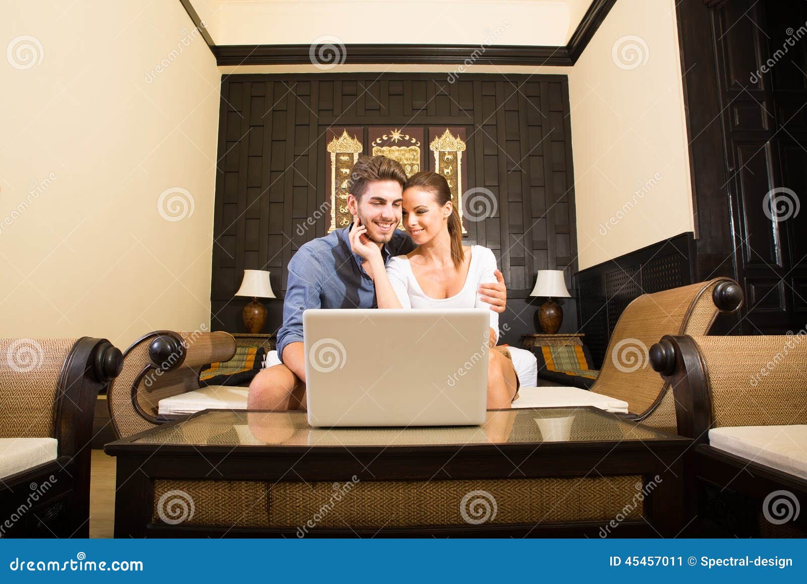 Young Couple Using a Laptop Computer in a Asian Hotel Room Stock Image ...