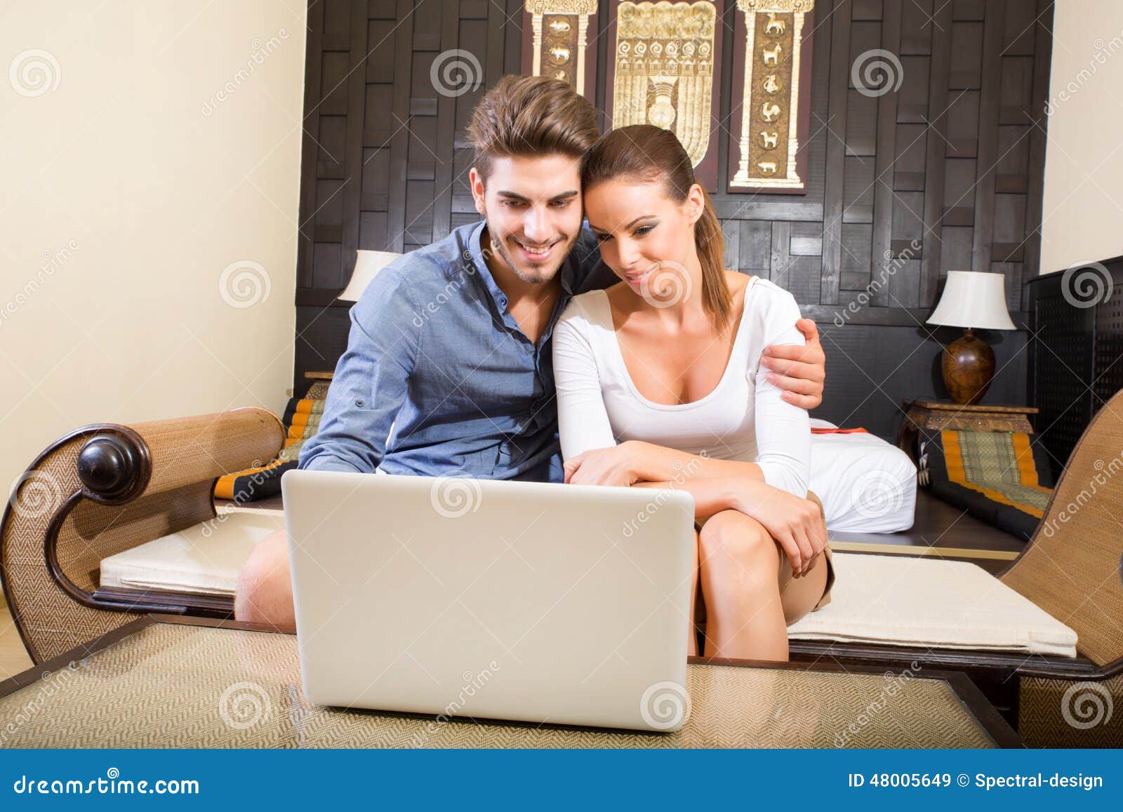 Young Couple Using a Laptop Computer in a Asian Hotel Room Stock Image ...