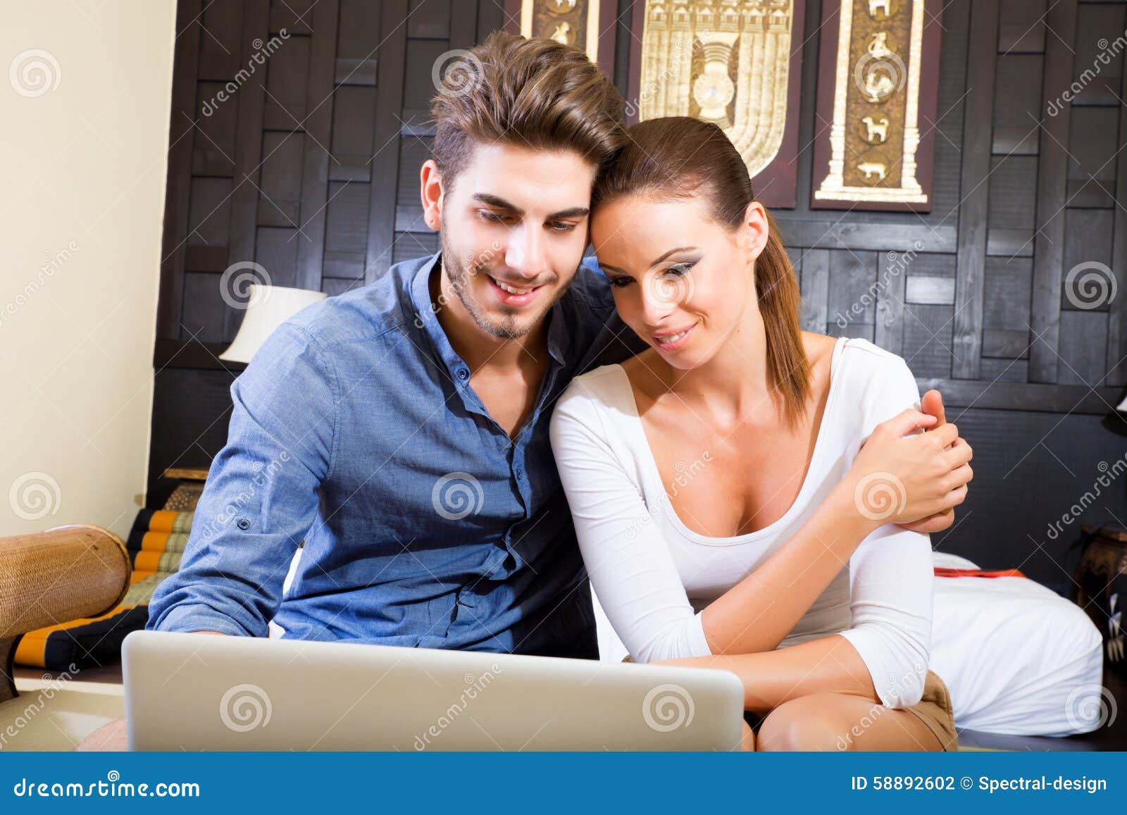Young Couple Using a Laptop Computer in a Asian Hotel Room Stock Photo ...
