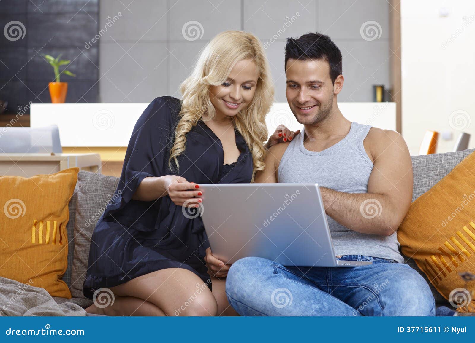 Young Couple Using Laptop Computer at Home Stock Image - Image of ...