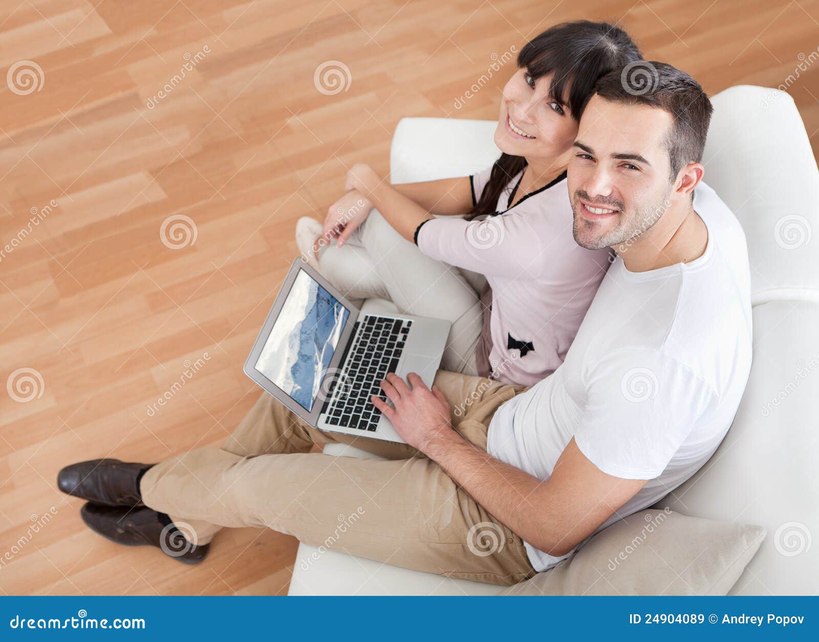 Young Couple Using Laptop in Couch Stock Image - Image of indoors ...