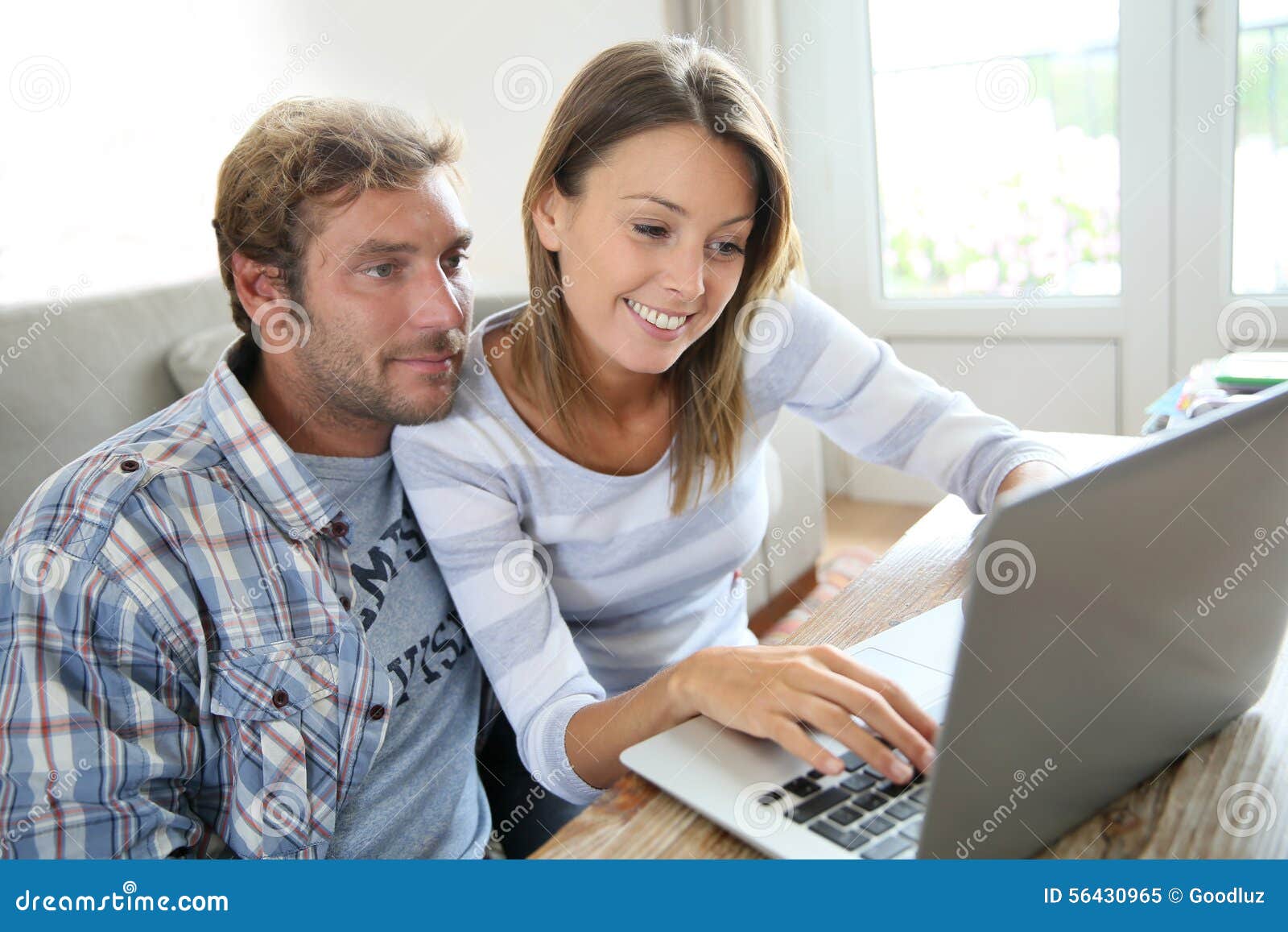 Young Couple Using Laptop at Home Stock Image - Image of young ...