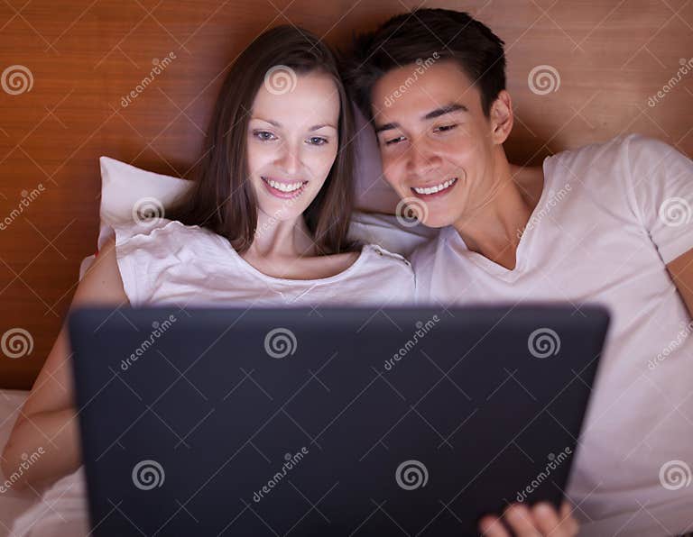 Young Couple in Bed with Laptop Stock Photo - Image of ecstatic ...