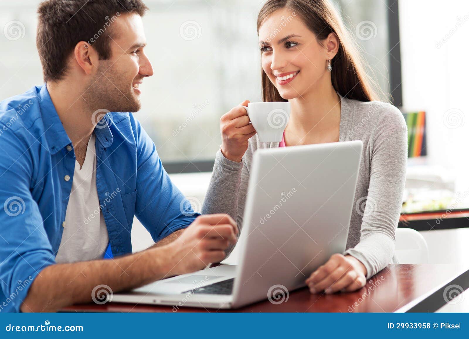 Couple Talking and Using Laptop at Cafe Stock Photo - Image of smiling ...