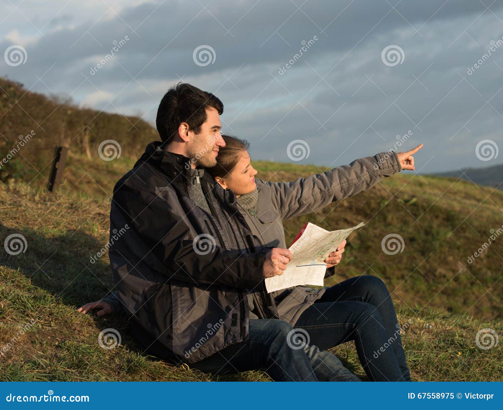 Young couple using map stock image. Image of fingerpost - 67558975