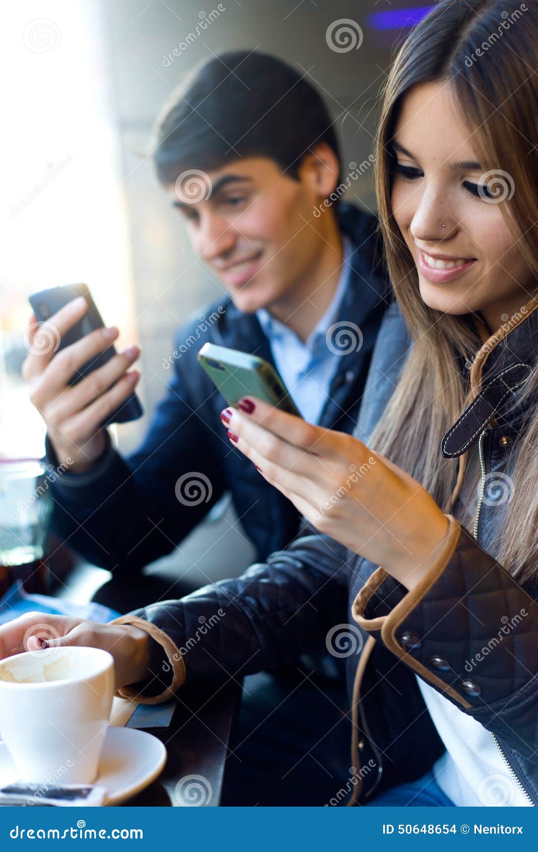 Young Couple Using Mobile Phone in Cafe. Stock Photo - Image of ...