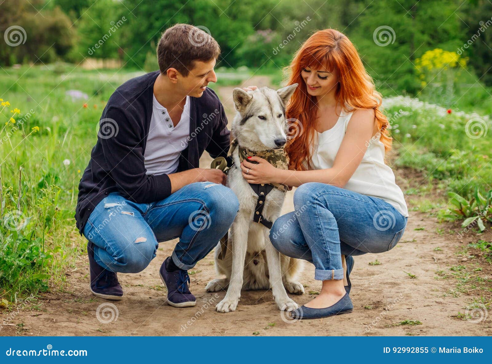 A Young Couple Walking a Dog in the Park Stock Image - Image of male ...