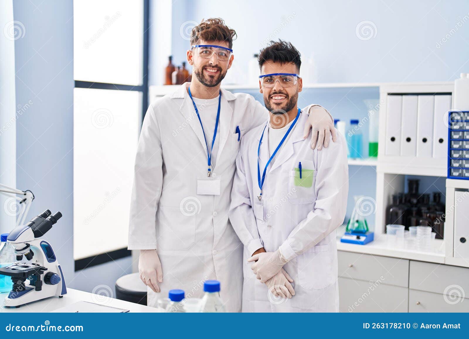Young Couple Wearing Scientist Uniform Hugging Each Other at Laboratory Stock Photo - Image of ...