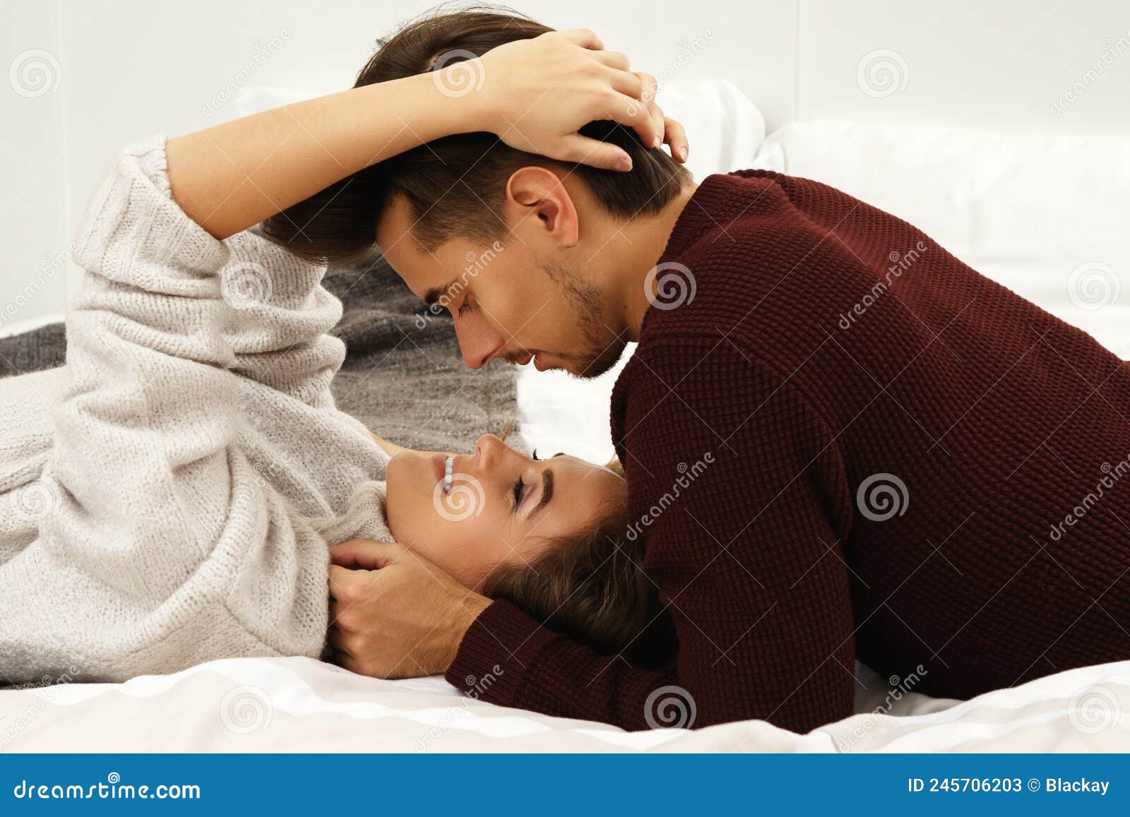 Couple Wearing Warm Sweaters and Lying on the Bed Stock Image - Image ...