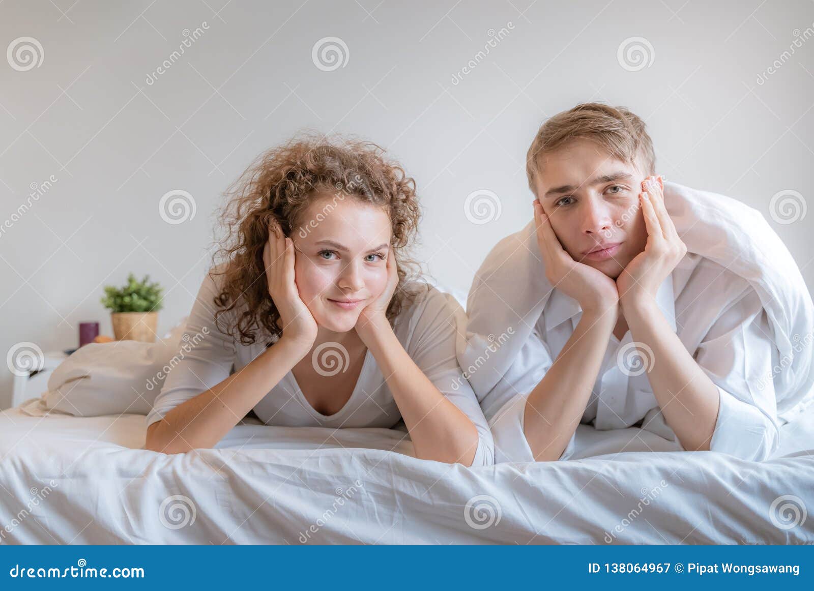 Young couples lie in bed. stock image. Image of human - 138064967