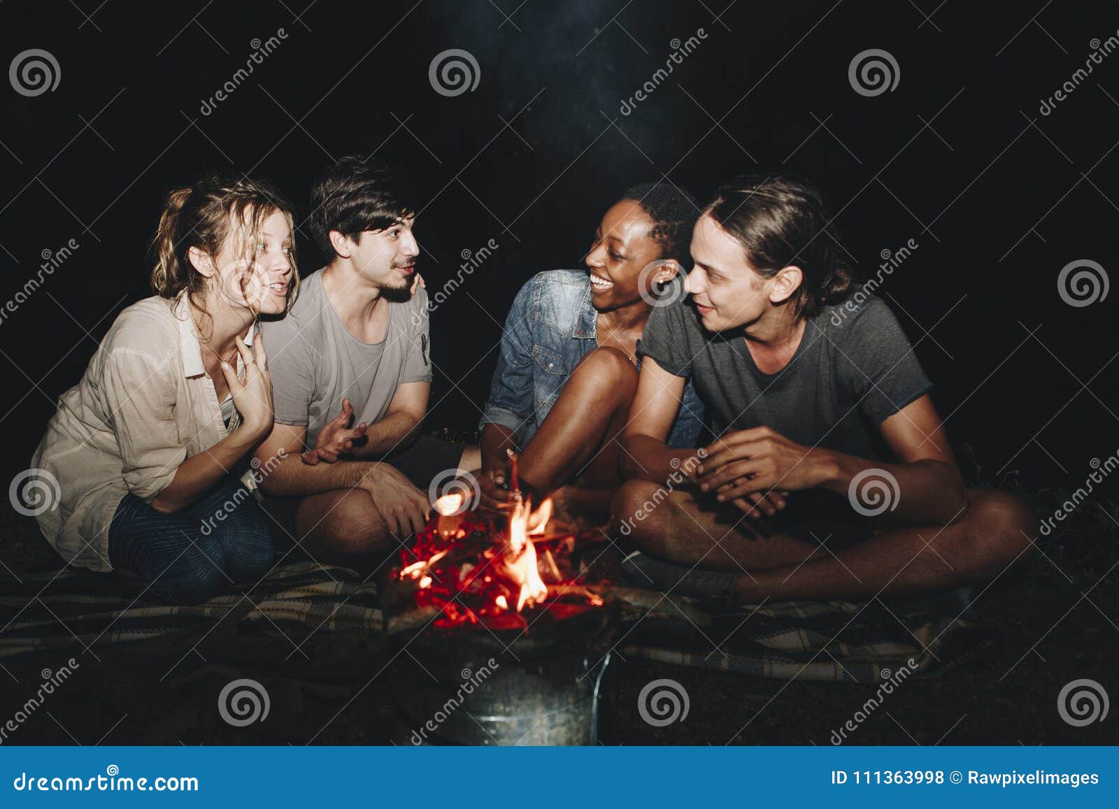Young Couples Sitting Around a Campfire Stock Photo - Image of ...