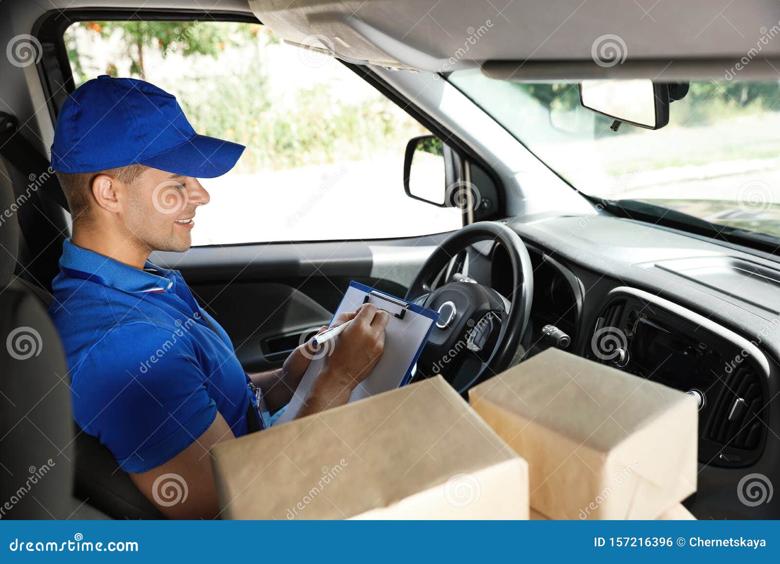 Young Courier with Clipboard and Parcels Stock Photo - Image of cargo ...