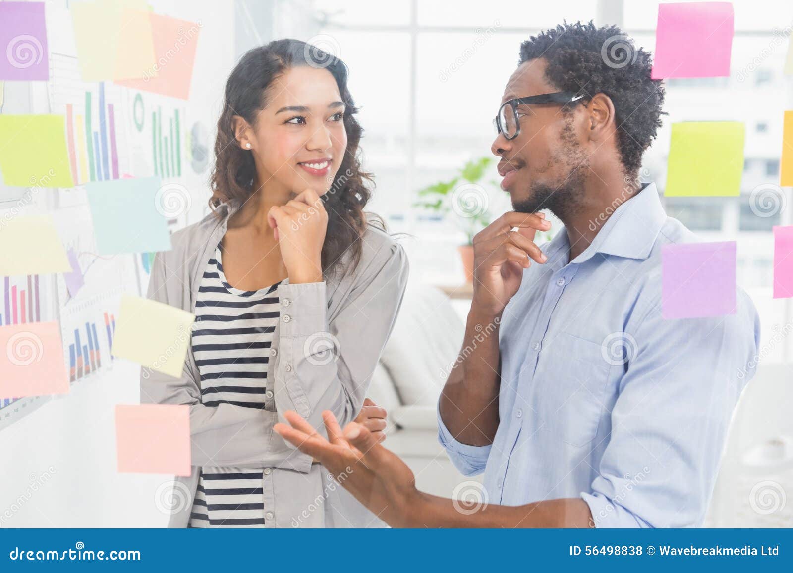 Young Creative Business People Talking To Each Other Stock Photo ...