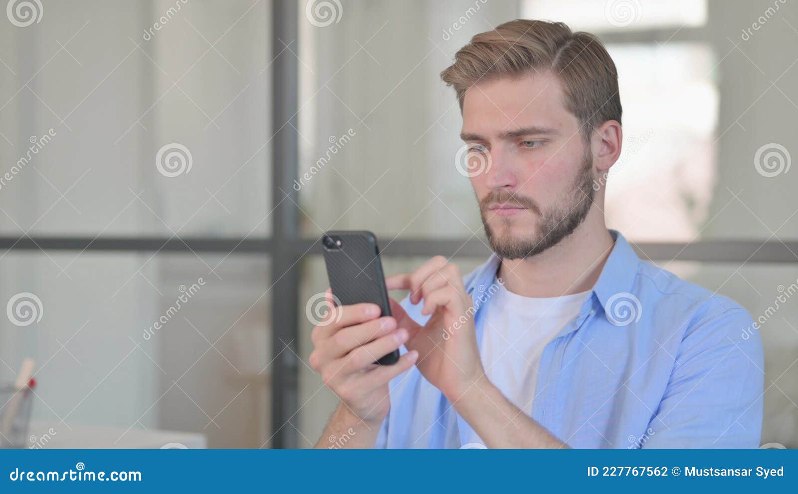 Young Man Browing Internet on Smartphone Stock Photo - Image of male ...