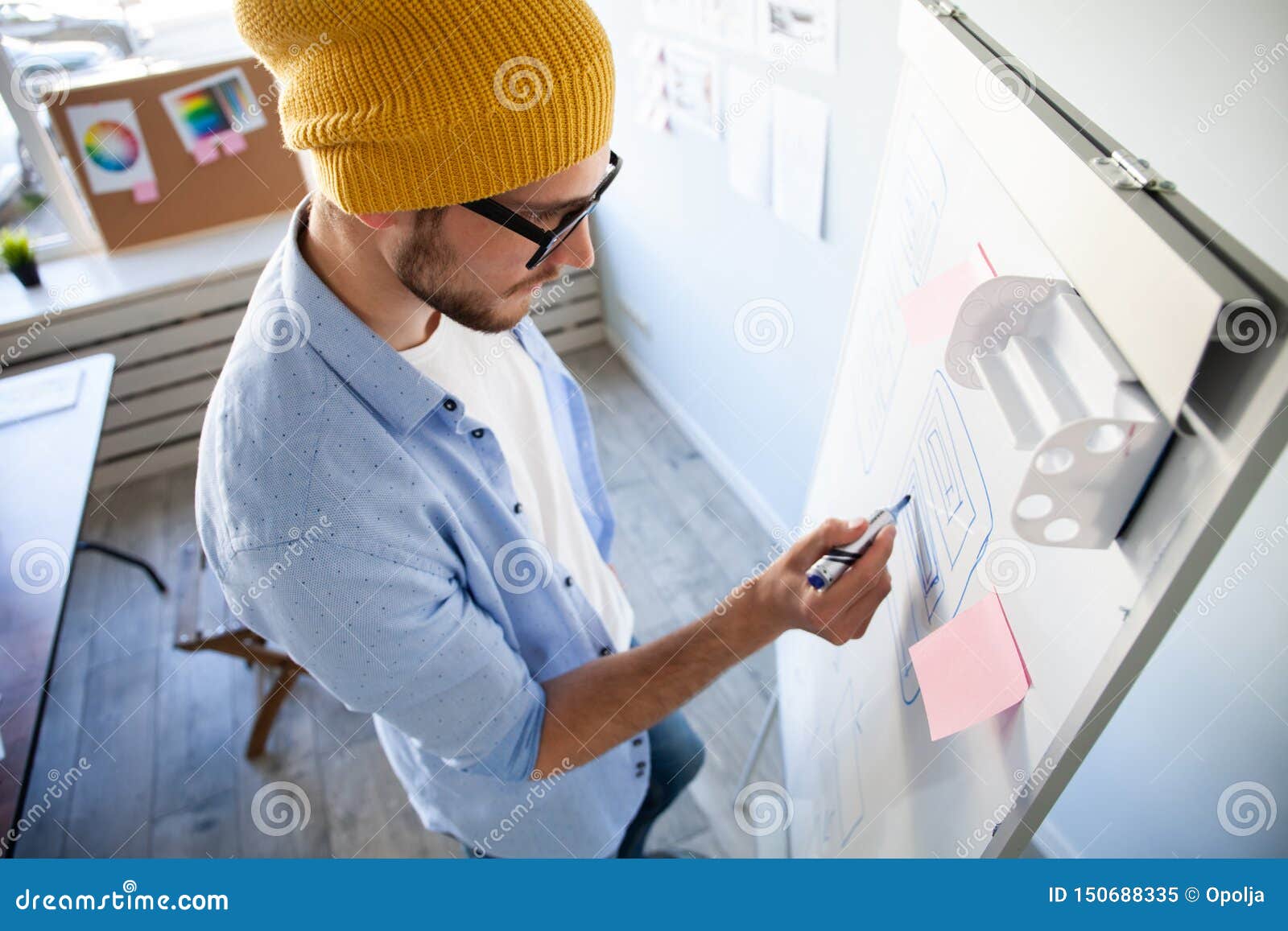 Young Creative Man Writing Down Ideas on Wall Full of Sticky Notes ...